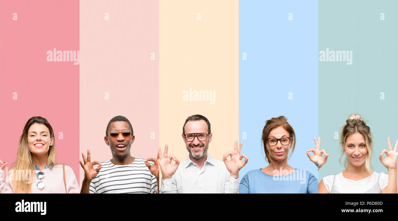 Mixed group of people, women and men doing ok sign gesture with both ...