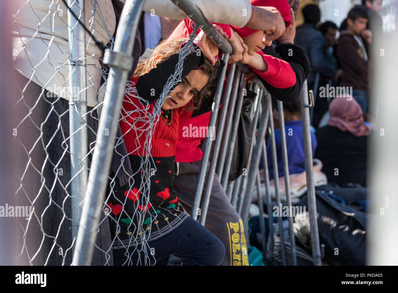 Children behind railings close to the gate as they wait to cross the ...