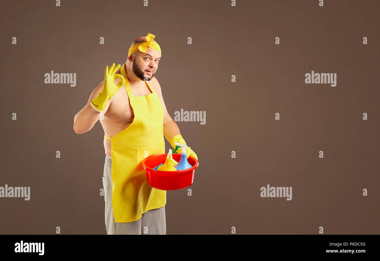 Funny fat cleaning man in an apron on cleaning on a background for text ...
