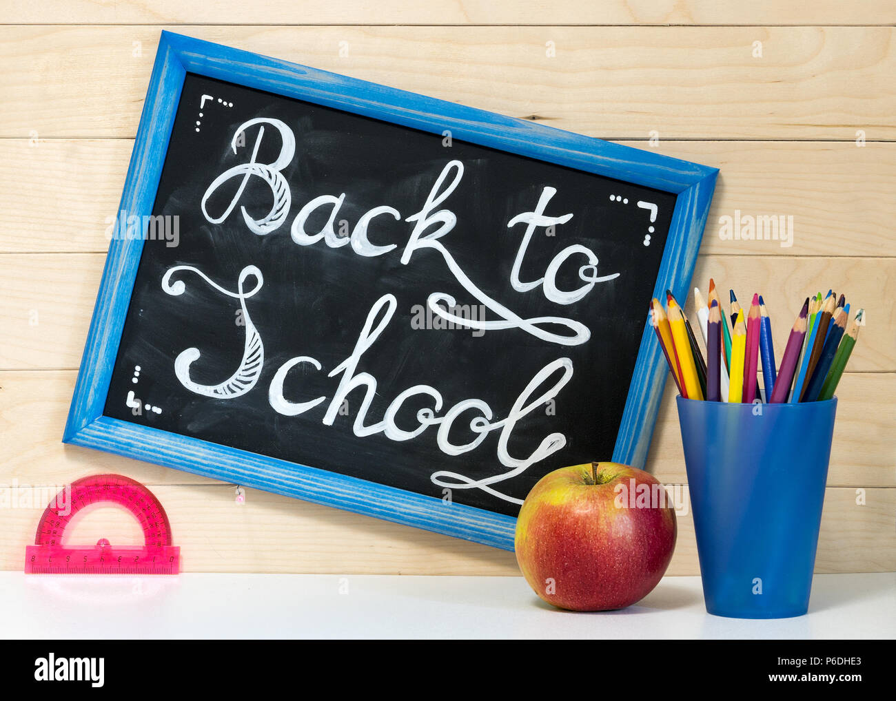 a board with an inscription chalk, back to school, a glass with pencils ...