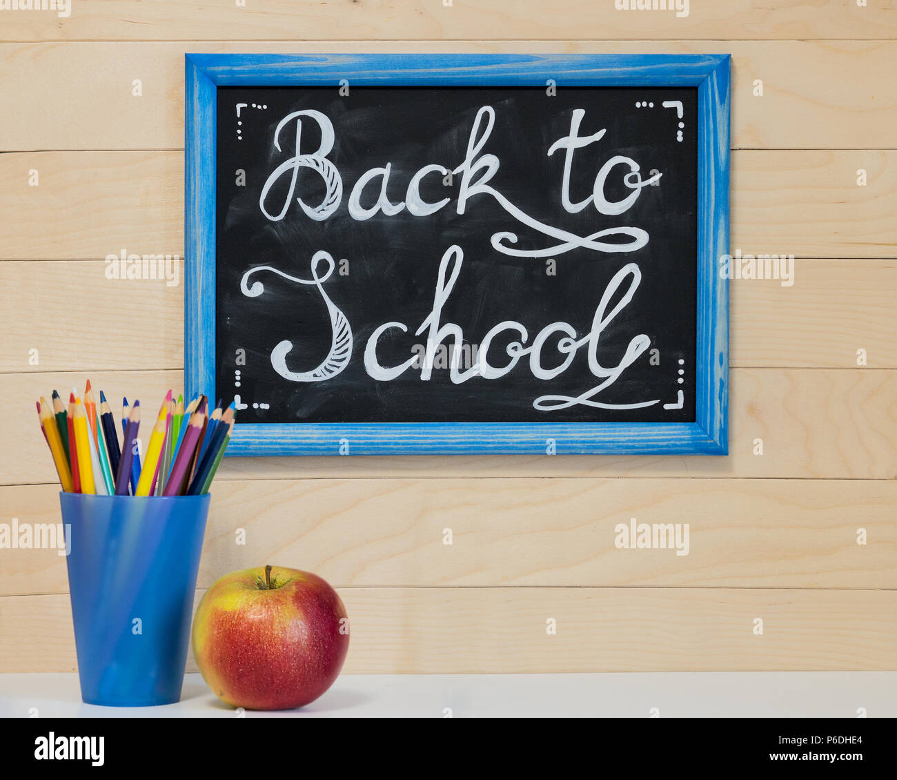 a board with an inscription chalk, back to school, a glass with pencils ...