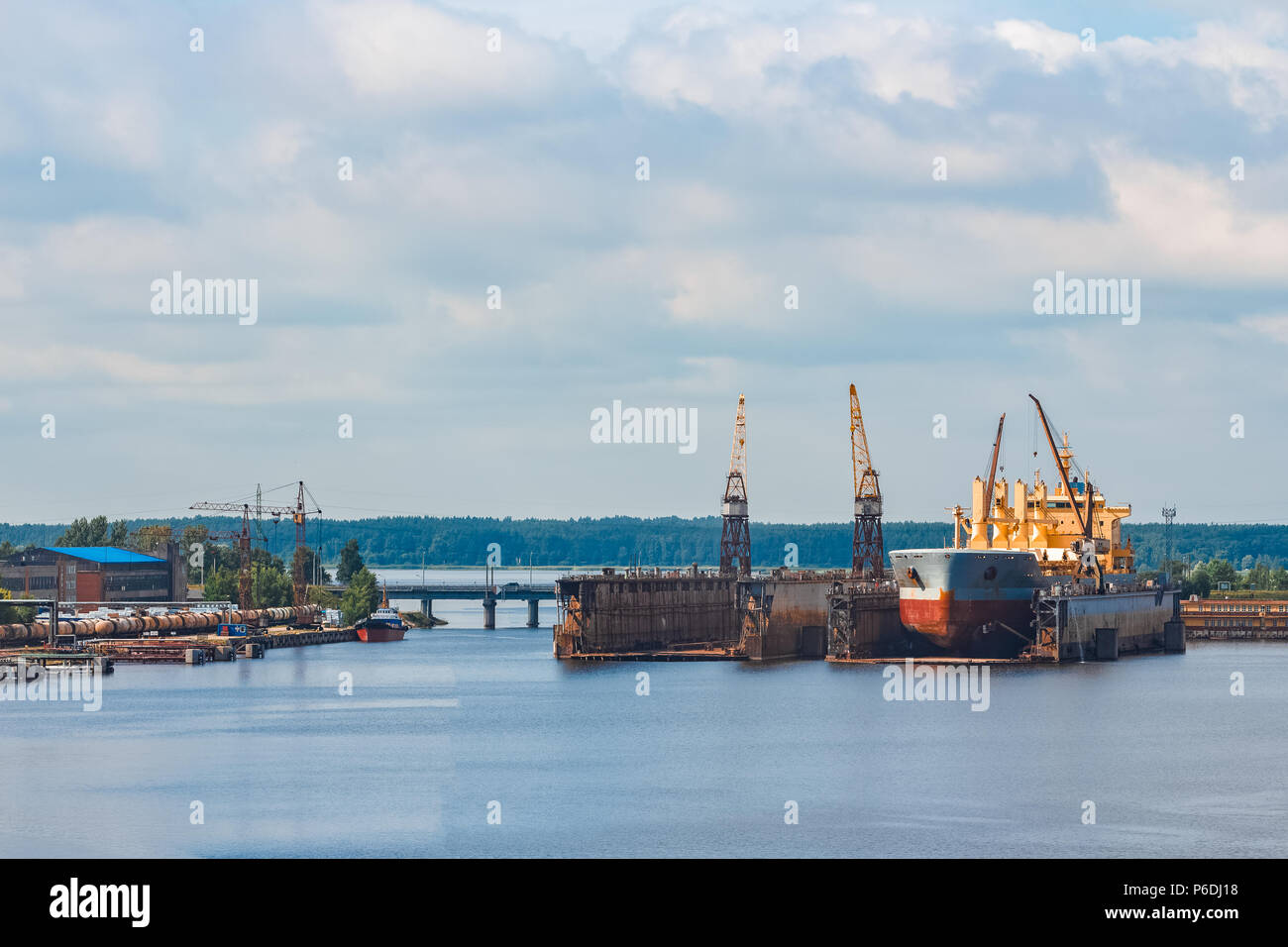 Yellow bulk carrier standing at the old shipyard in the dock Stock ...