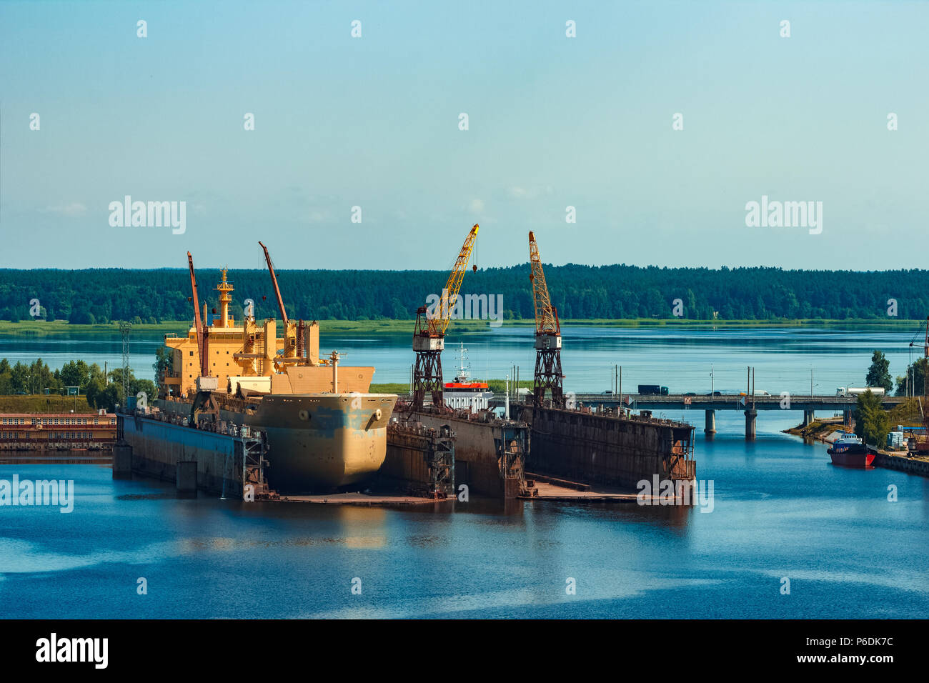 Yellow bulk carrier standing at the old shipyard in the dock Stock ...