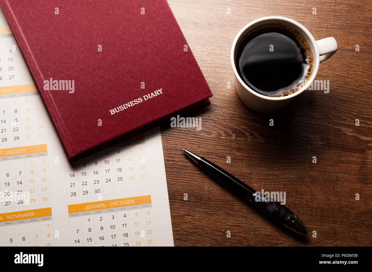 diary with large pen on the oak desk still life Stock Photo - Alamy