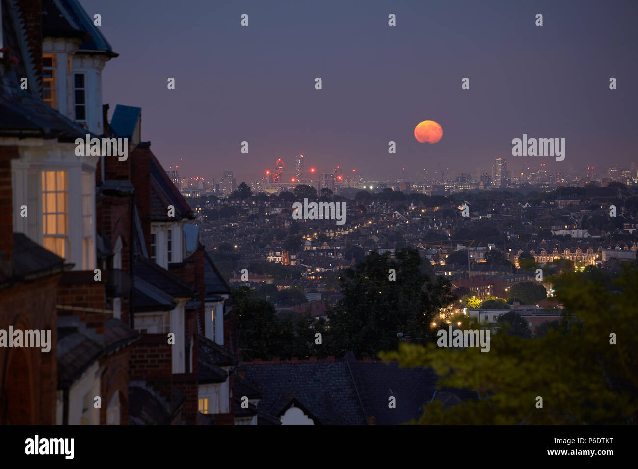 London, UK, 29 June 2018. Moonrise over London seen from Muswell Hill ...