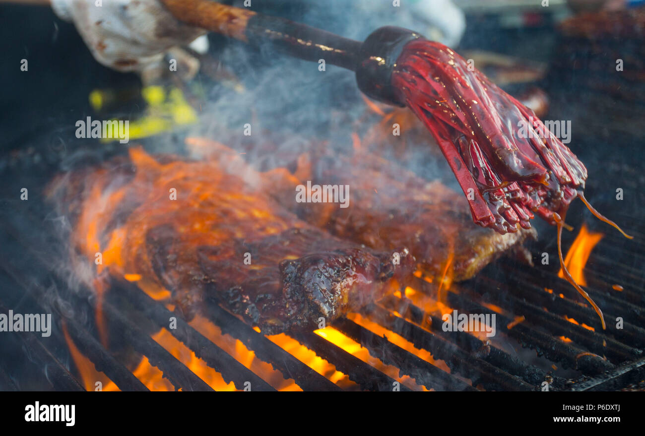 Toronto, Canada. 29th June, 2018. A barbequer adds a thick coating of ...