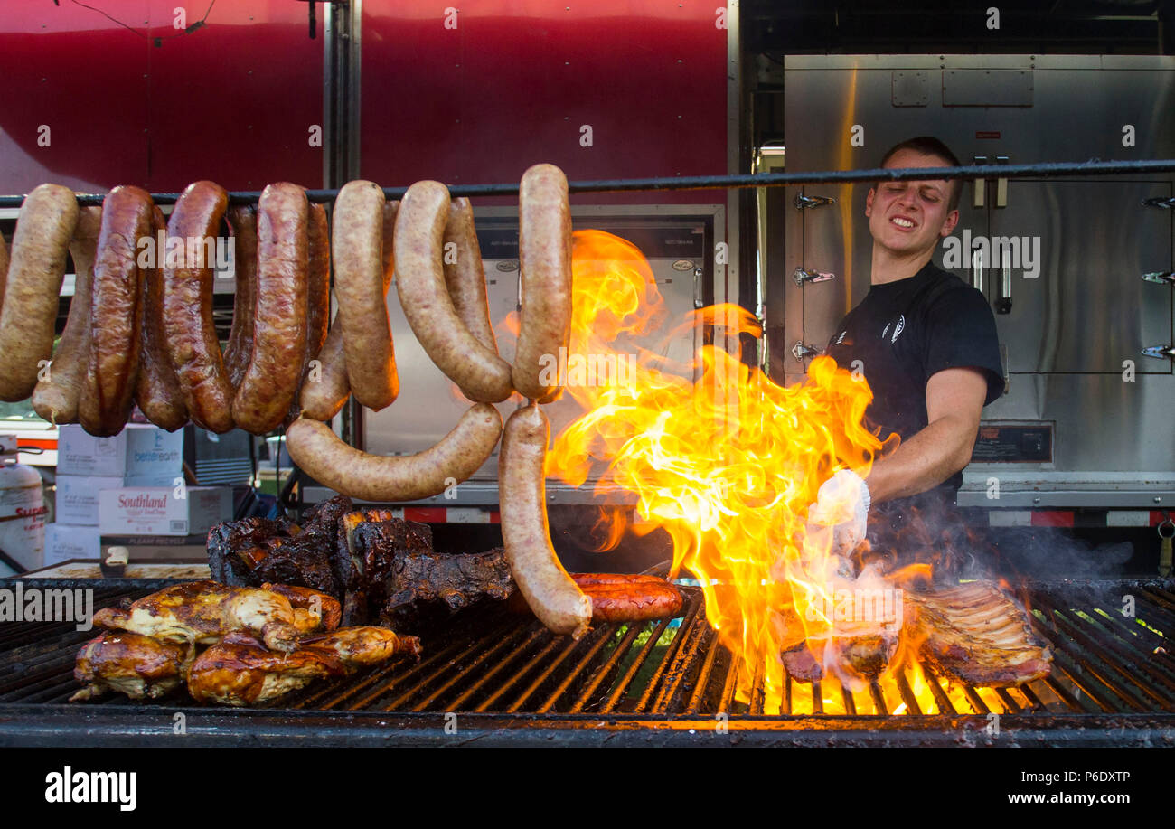 Toronto, Canada. 29th June, 2018. A barbequer works on ribs during the ...