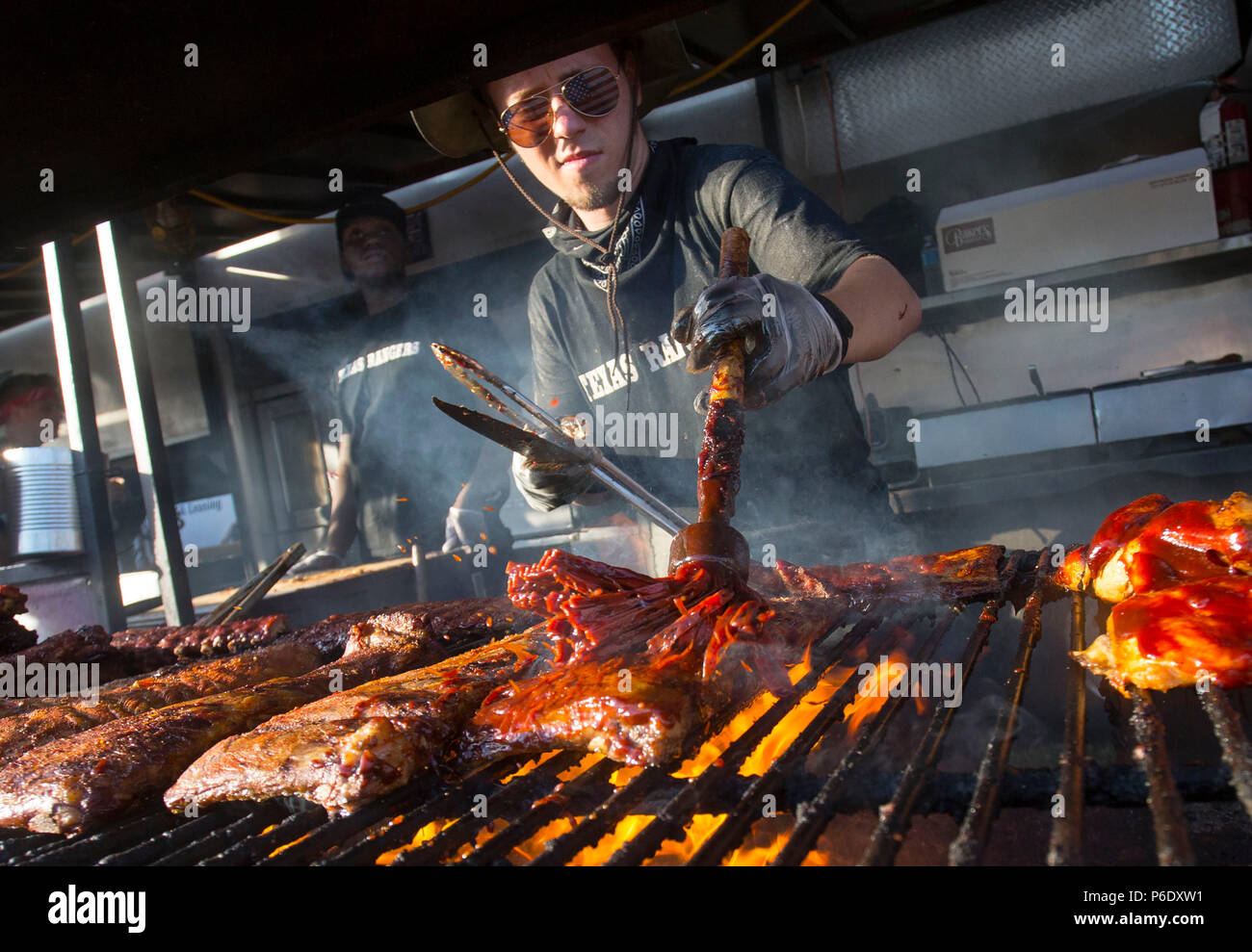 Toronto, Canada. 29th June, 2018. A barbequer adds a thick coating of ...