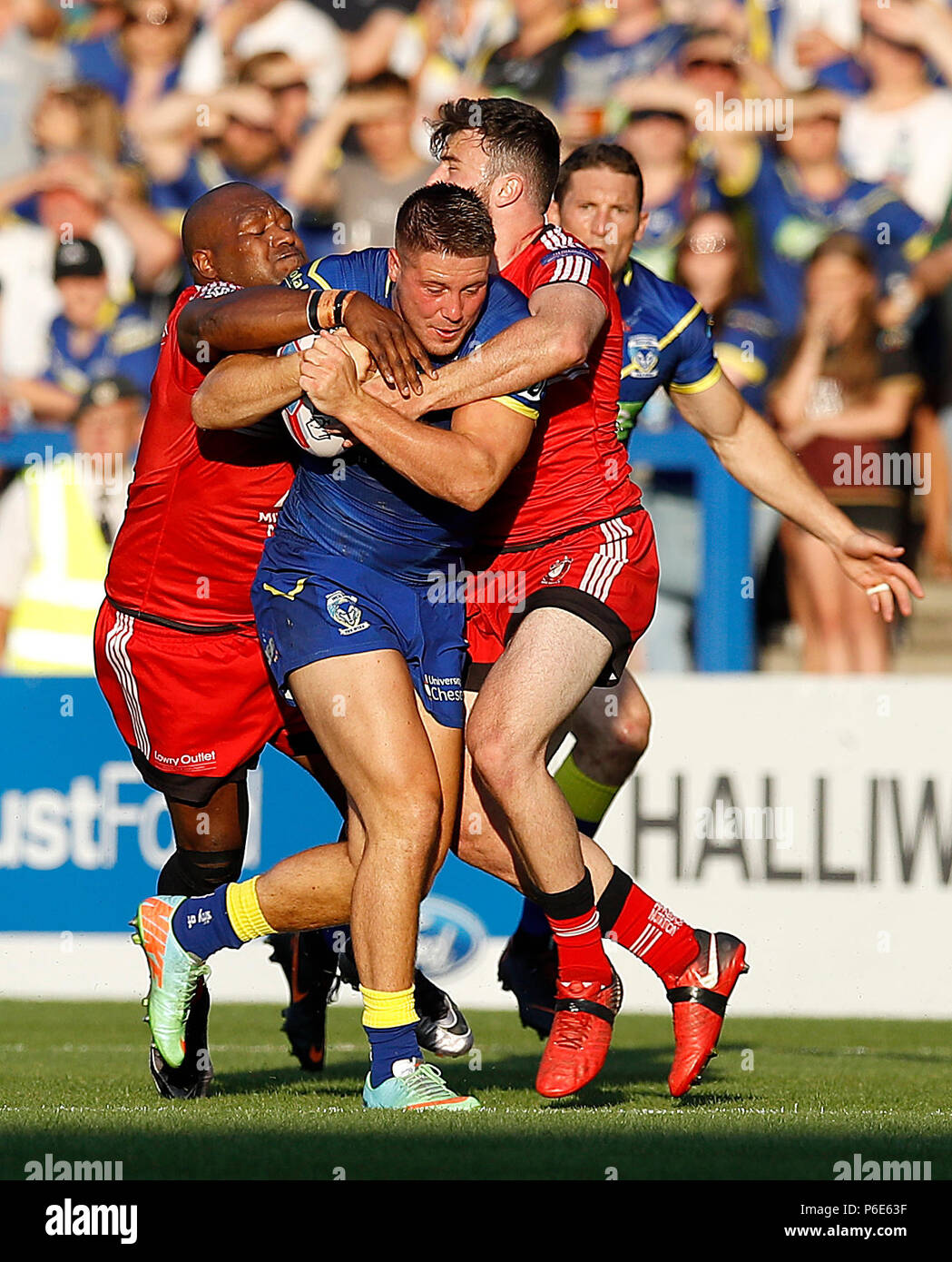 Warrington Wolves' Tom Lineham is tackled by Salford Red Devils' Robert ...