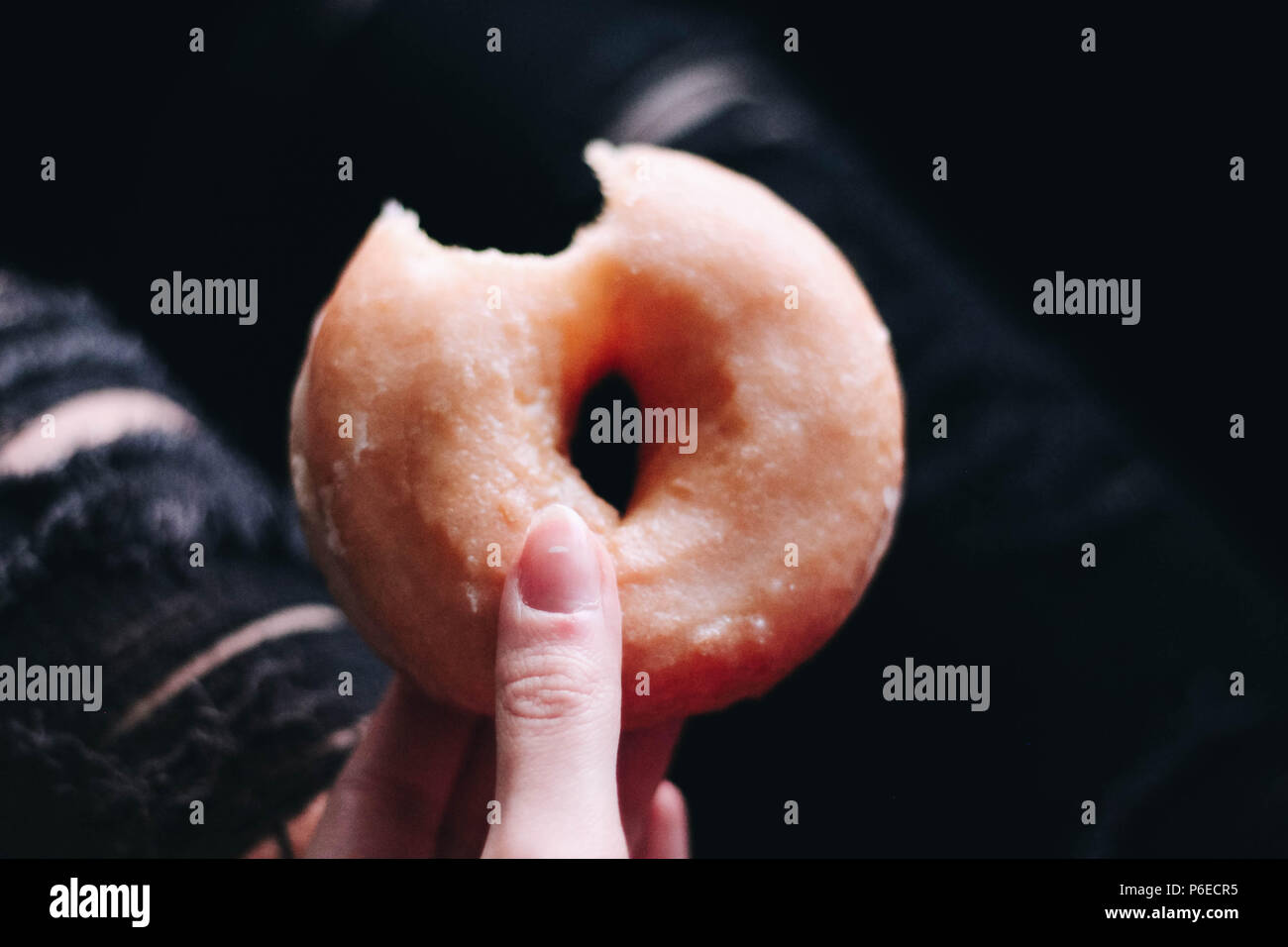 Closeup of a donut with legs of the background Stock Photo - Alamy