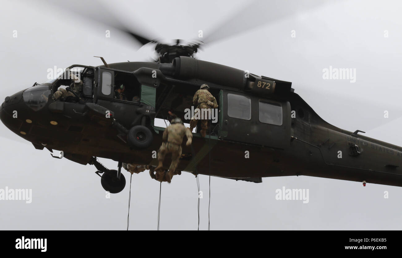 Soldiers and Airmen rappel from a UH-60 helicopter during the final ...