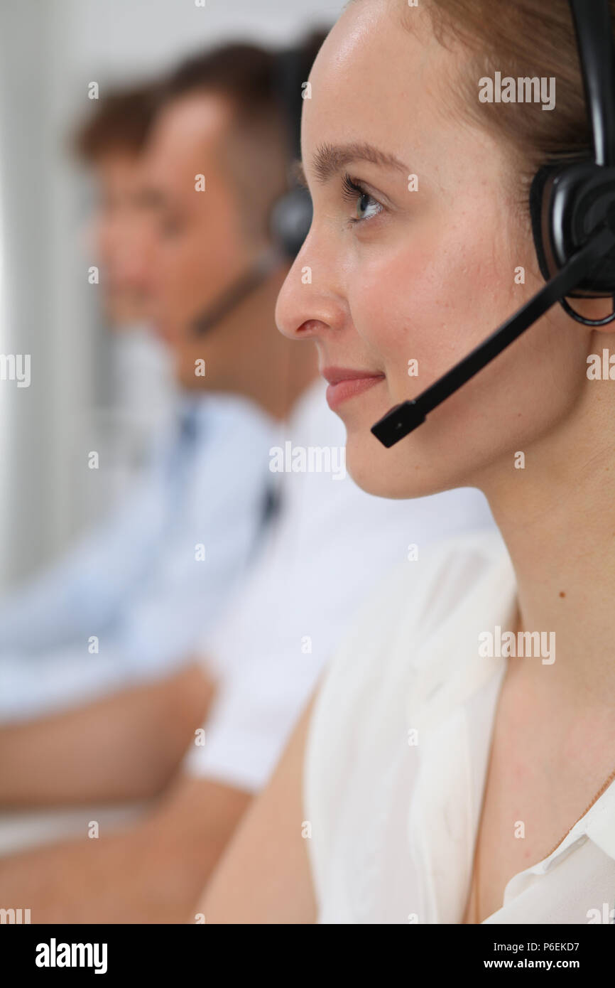 Call center. Focus on beautiful woman in headset Stock Photo - Alamy