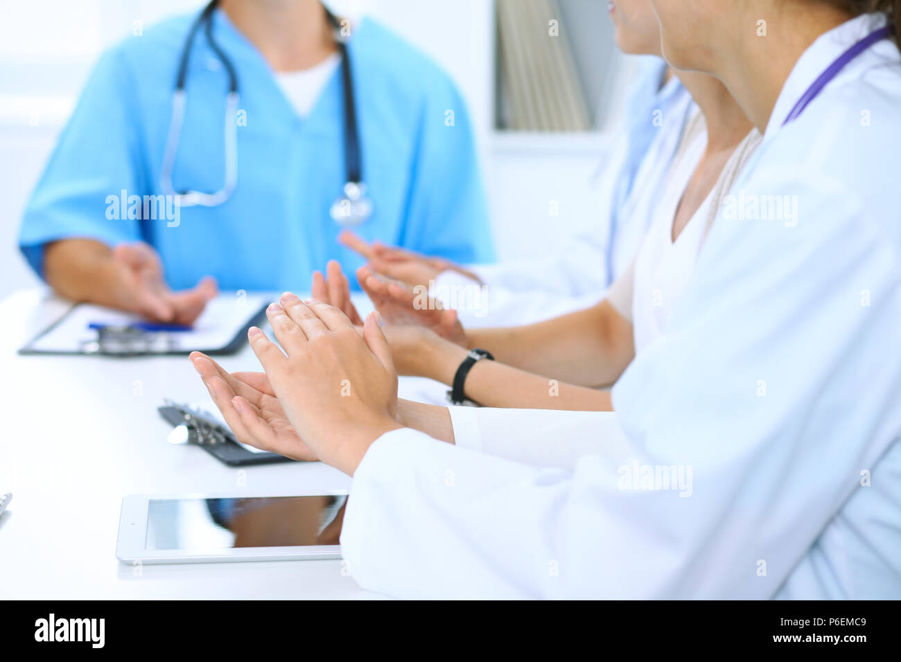 Group of doctors applauding at medical meeting. Close up of physician ...
