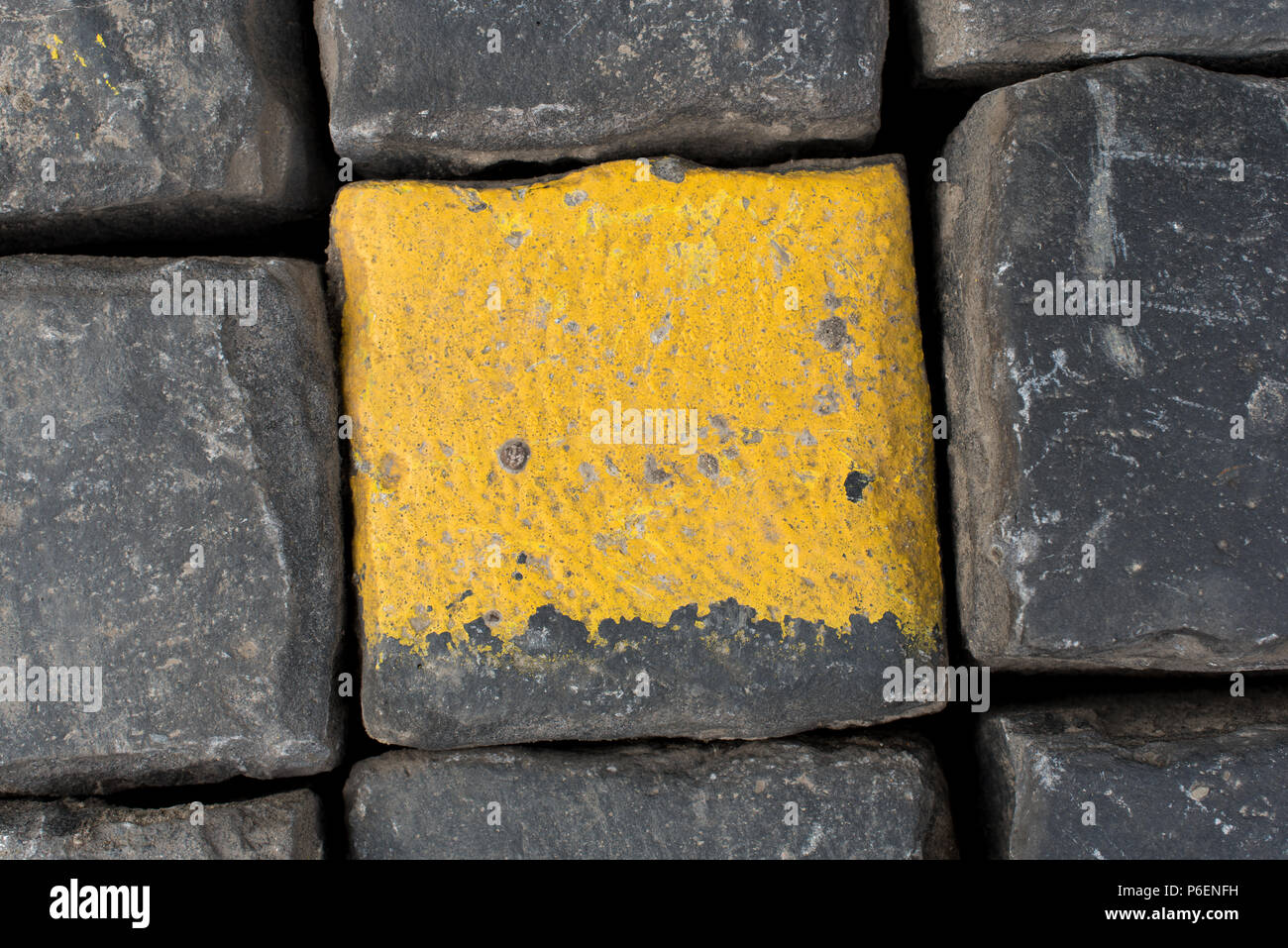 Old yellow and black granite road cubes as background or wallpaper ...