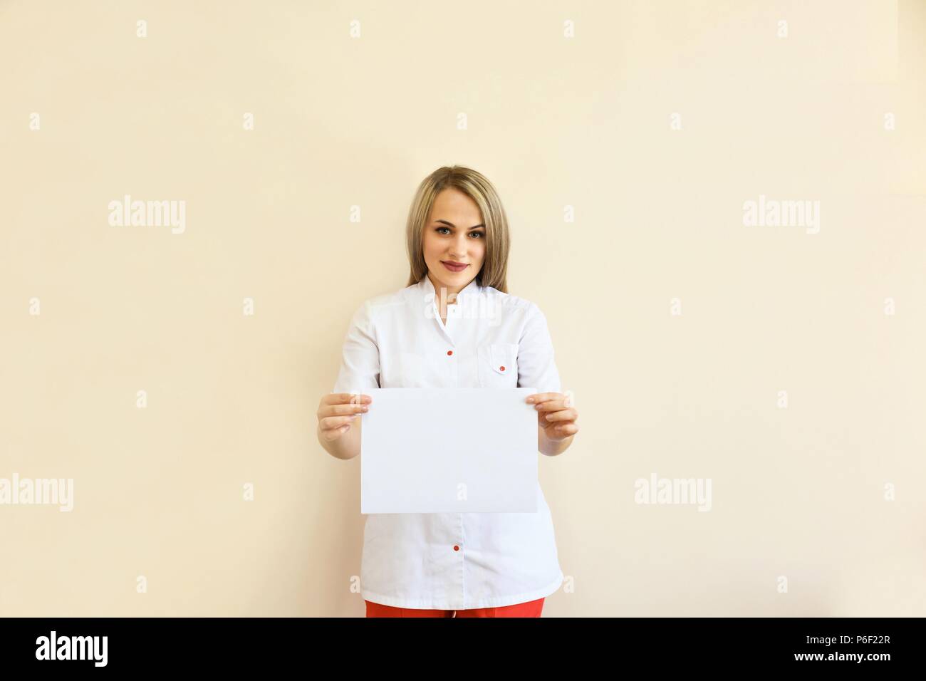 Nurse showing medical sign billboard standing in full length. Young ...