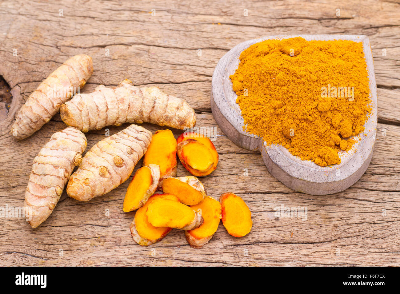 powder and roots of turmeric on wood - curcuma longa Stock Photo - Alamy