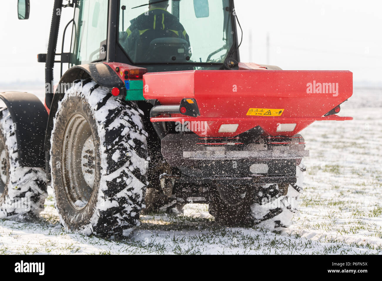 Farmer with tractor seeding - sowing crops at agricultural fields in ...