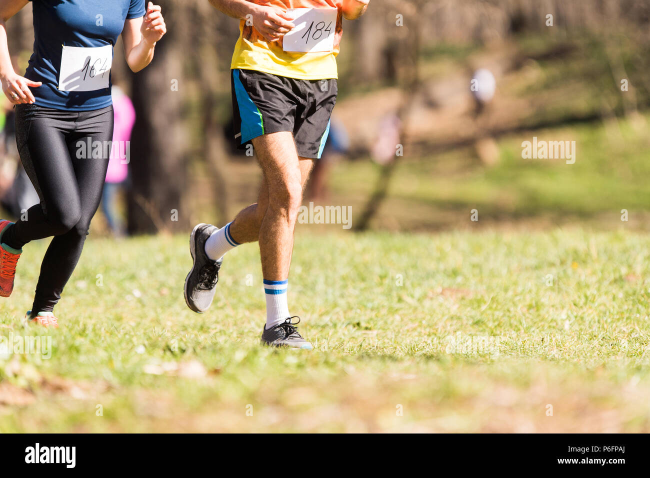Marathon running race, people feet on grass road Stock Photo - Alamy