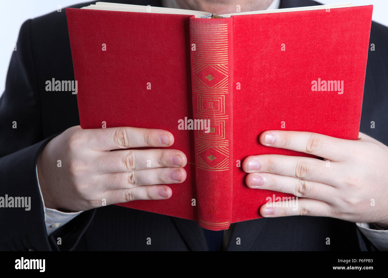 man holding an open red book closeup on a white Stock Photo - Alamy
