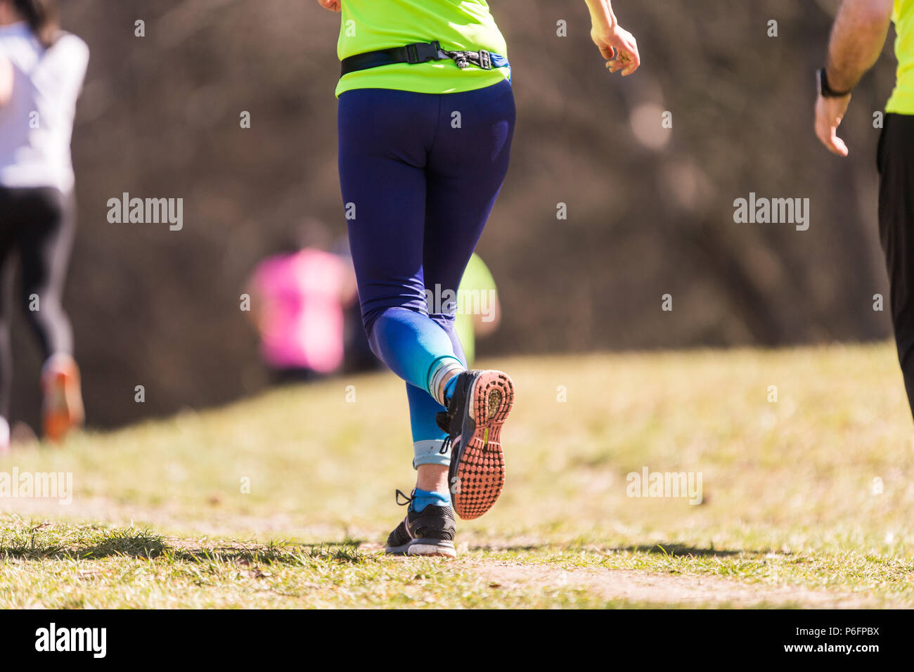 Marathon running race, people feet on grass road Stock Photo - Alamy