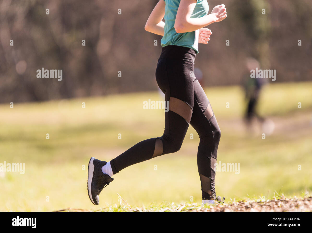 Marathon running race, people feet on grass road Stock Photo - Alamy