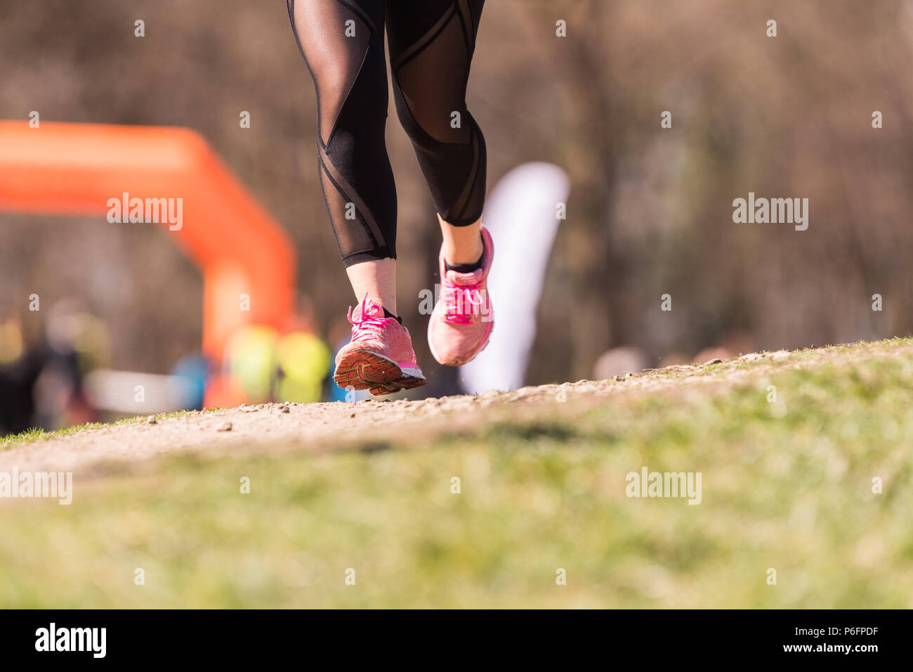Marathon running race, people feet on grass road Stock Photo - Alamy