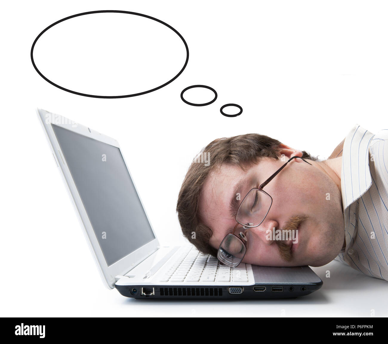 man sleeping on a notebook keyboard at the workplace on a white Stock ...