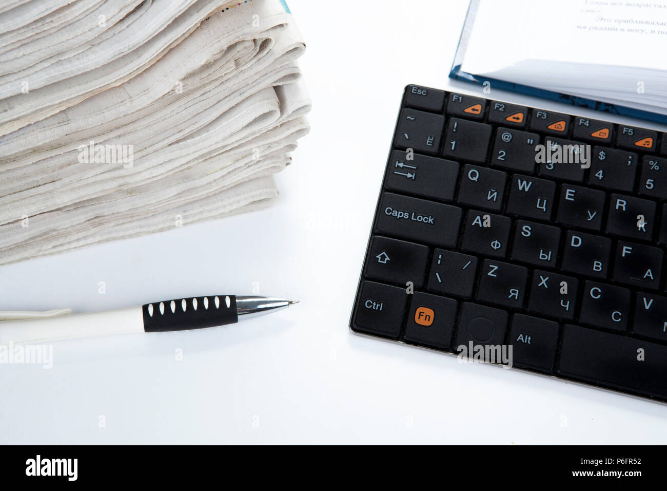 stack of newspapers and keyboard closeup Stock Photo - Alamy