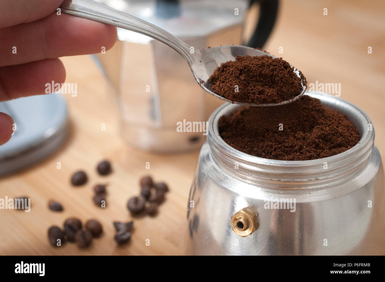 Hand put fresh ground coffee into an italian moka pot Stock Photo - Alamy
