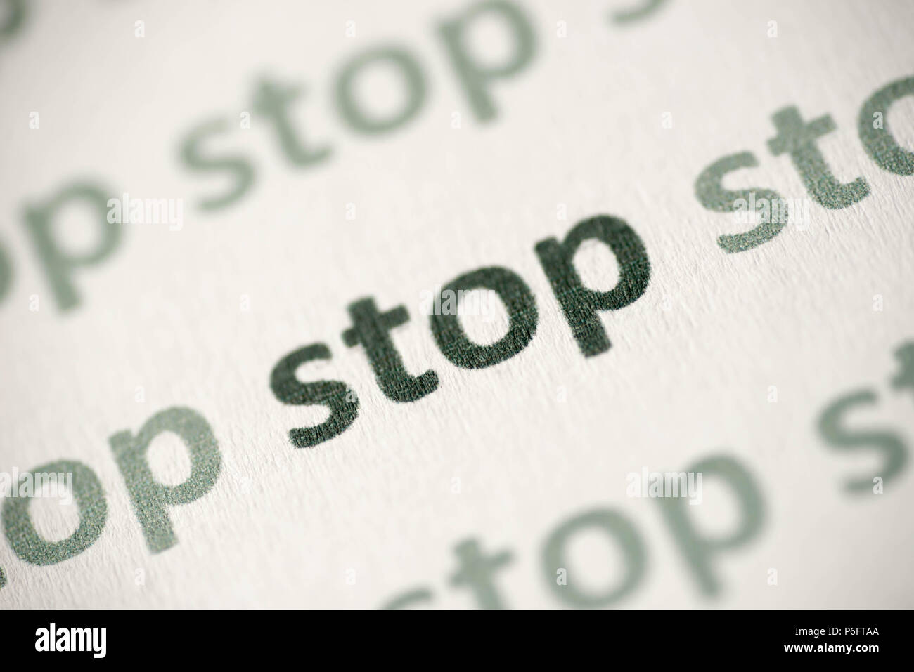 word stop printed on white paper macro Stock Photo - Alamy