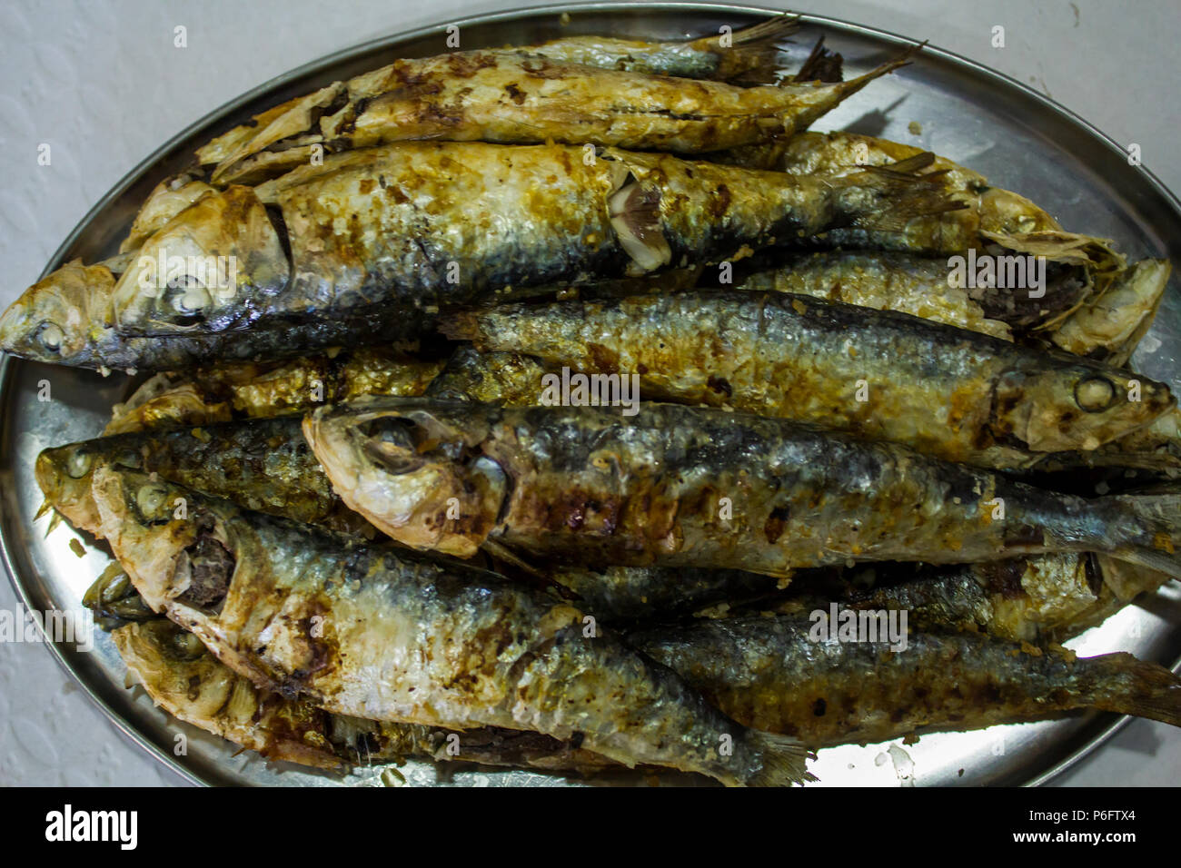 Grilled sardines on a silver plate. Top View Stock Photo - Alamy
