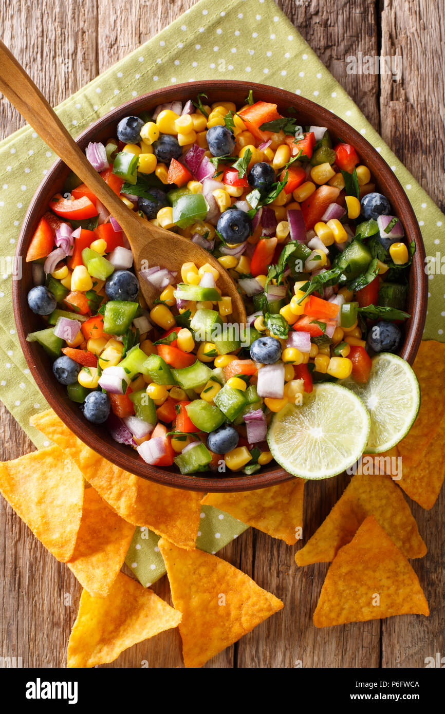 Salsa salad made from corn, blueberries, peppers and onions served with ...