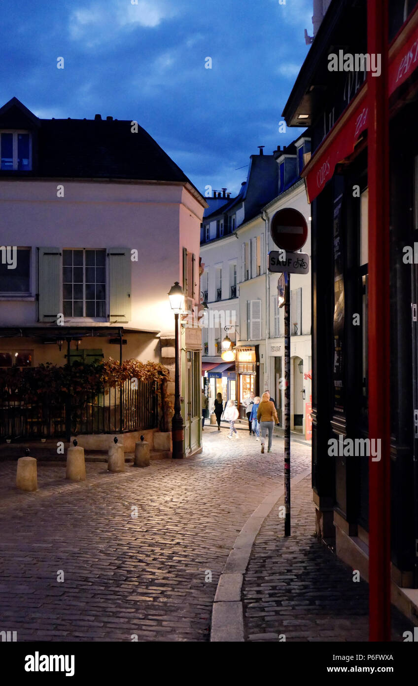 Cobblestone street in Paris during the evening Stock Photo - Alamy