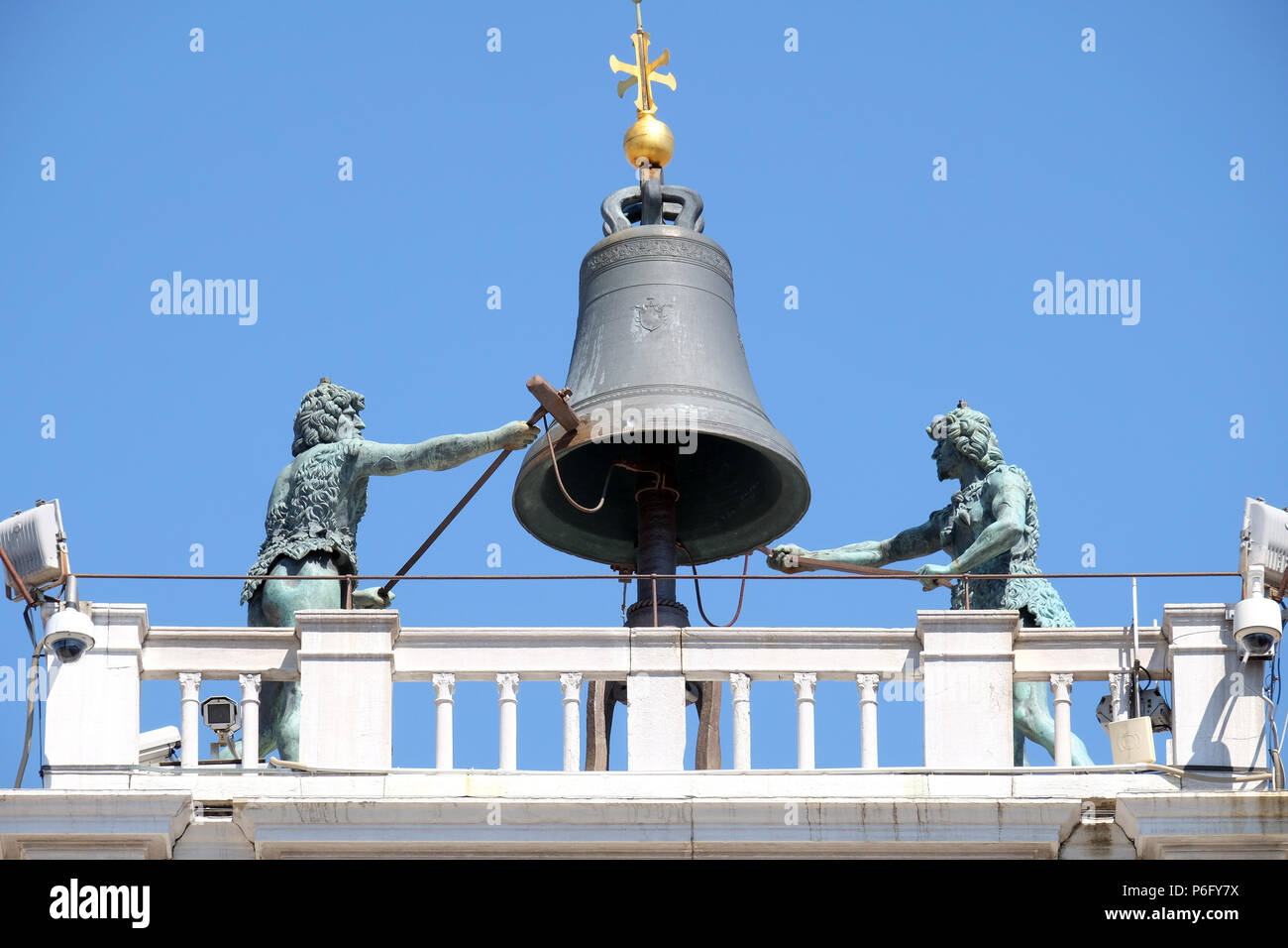 The bell on top of an ancient Clock Tower Torre dell`Orologio in the ...