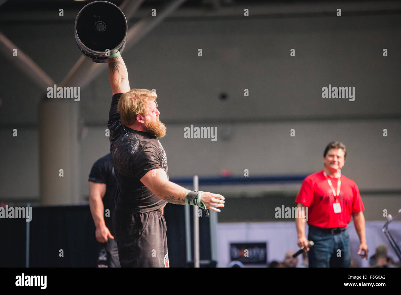 man competing in a dumbbell competition on stage Stock Photo - Alamy