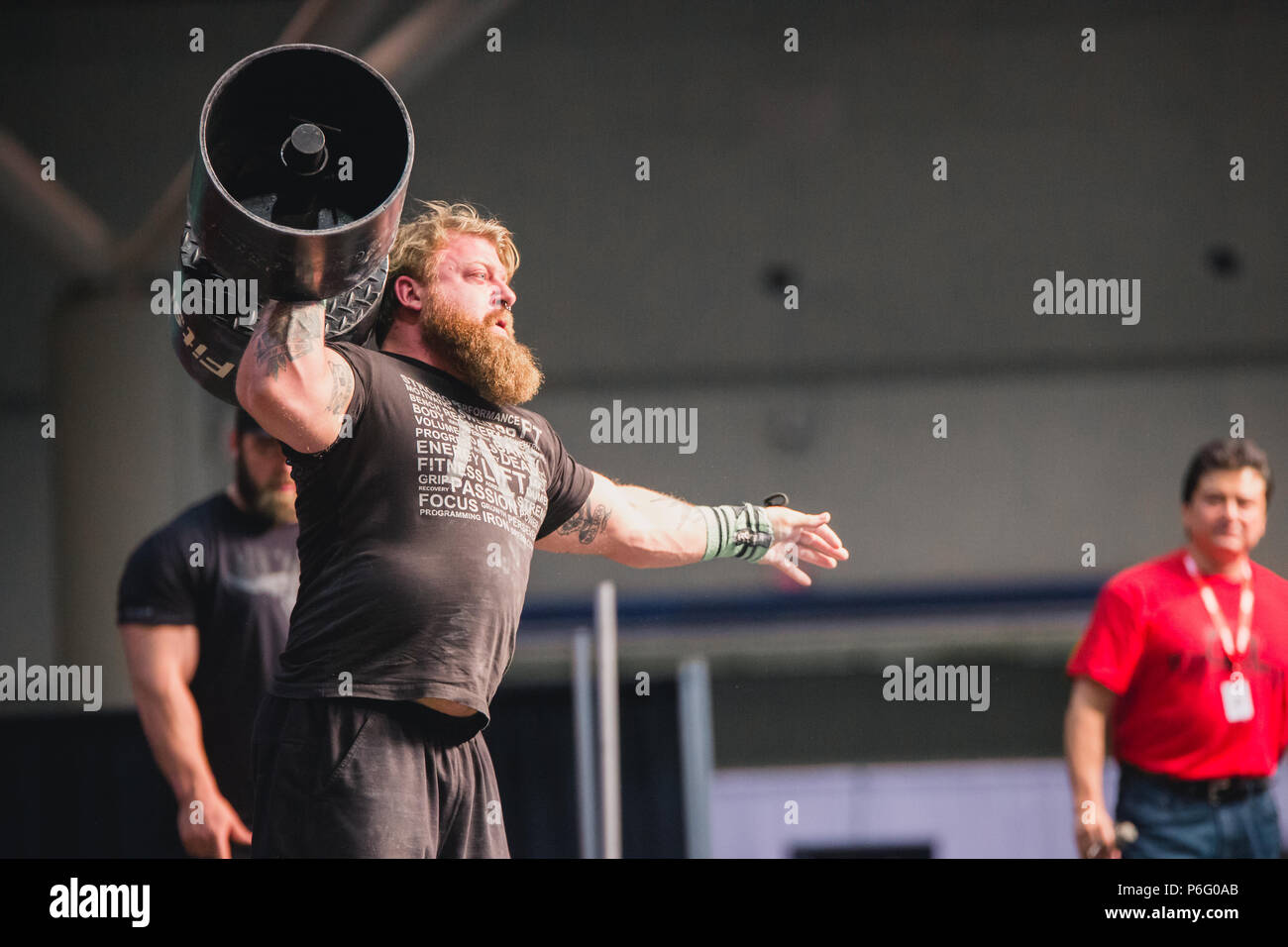 man competing in a dumbbell competition on stage Stock Photo - Alamy