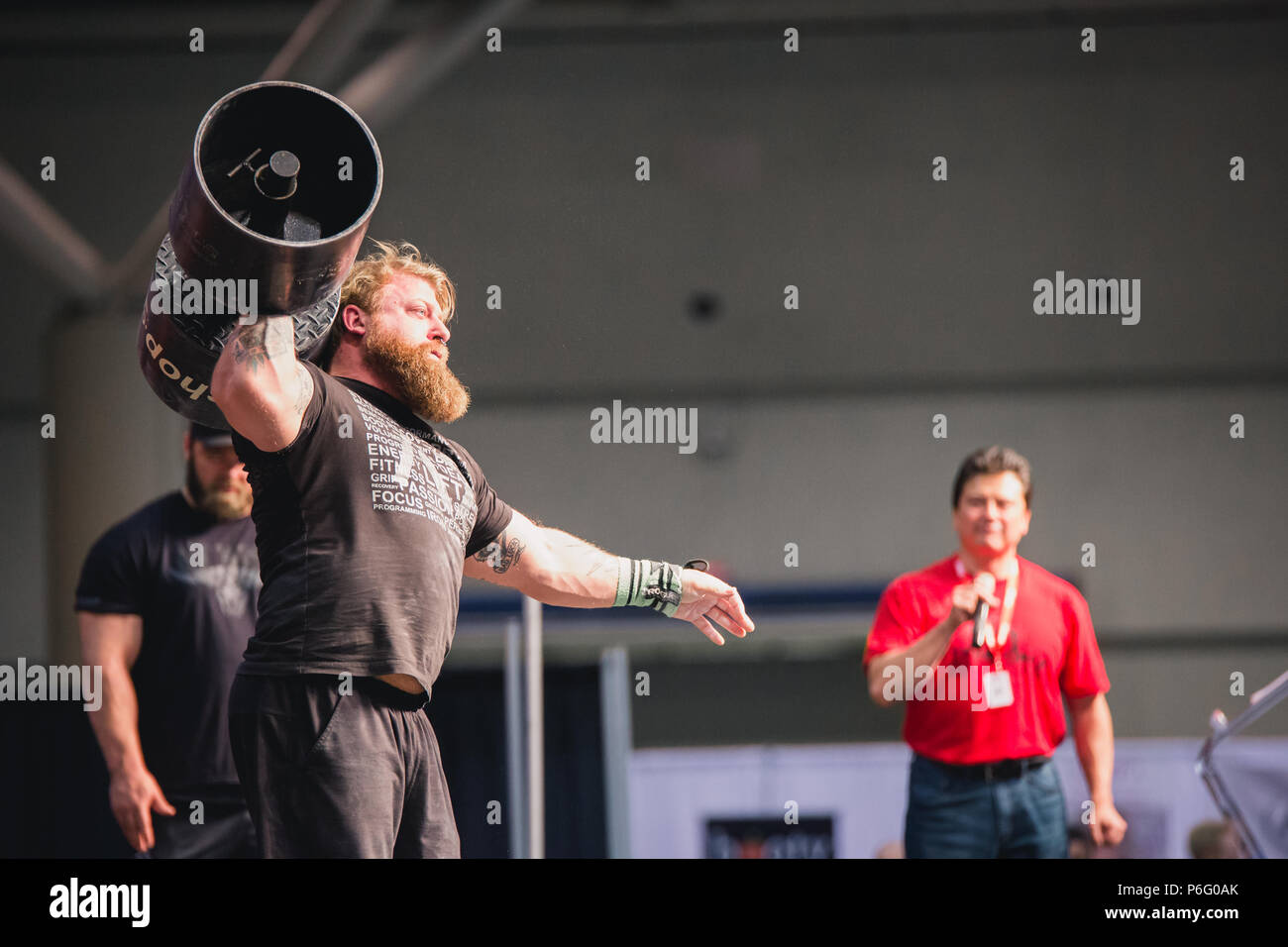 man competing in a dumbbell competition on stage Stock Photo - Alamy