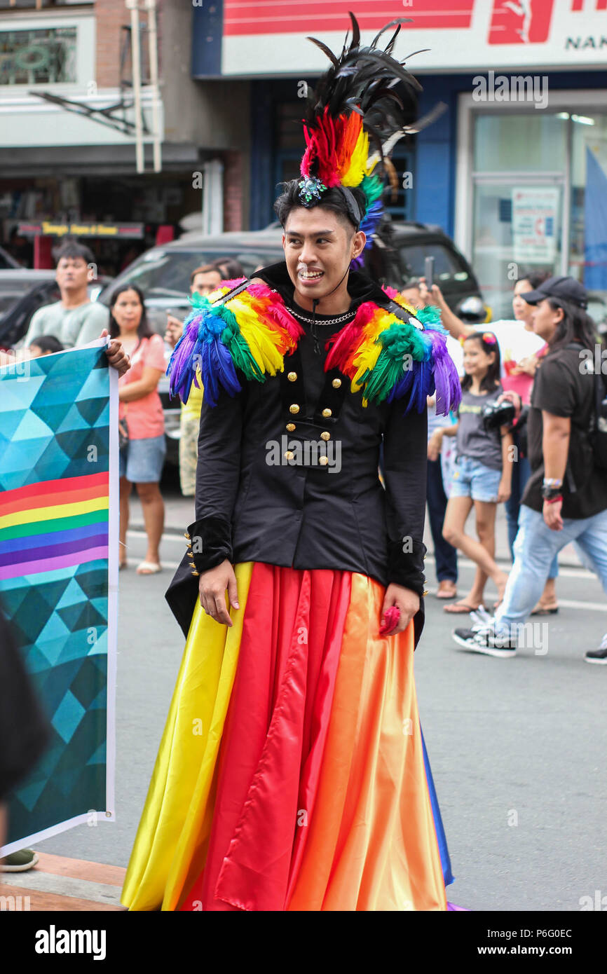 A participant in a rainbow costume. Thousands gathered around the ...