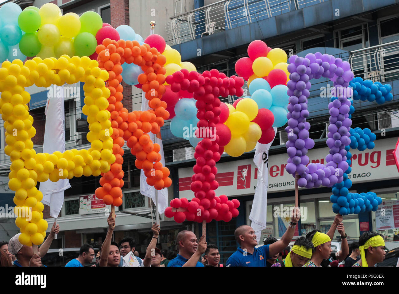 Participants holding letters made out of the balloons. Thousands ...