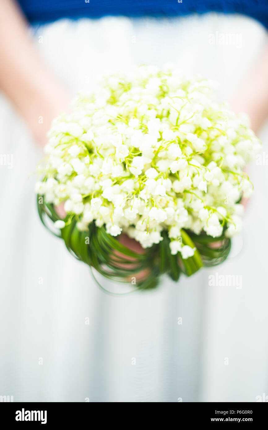Beautiful may lilies in bride bunch on rustic background with copy ...