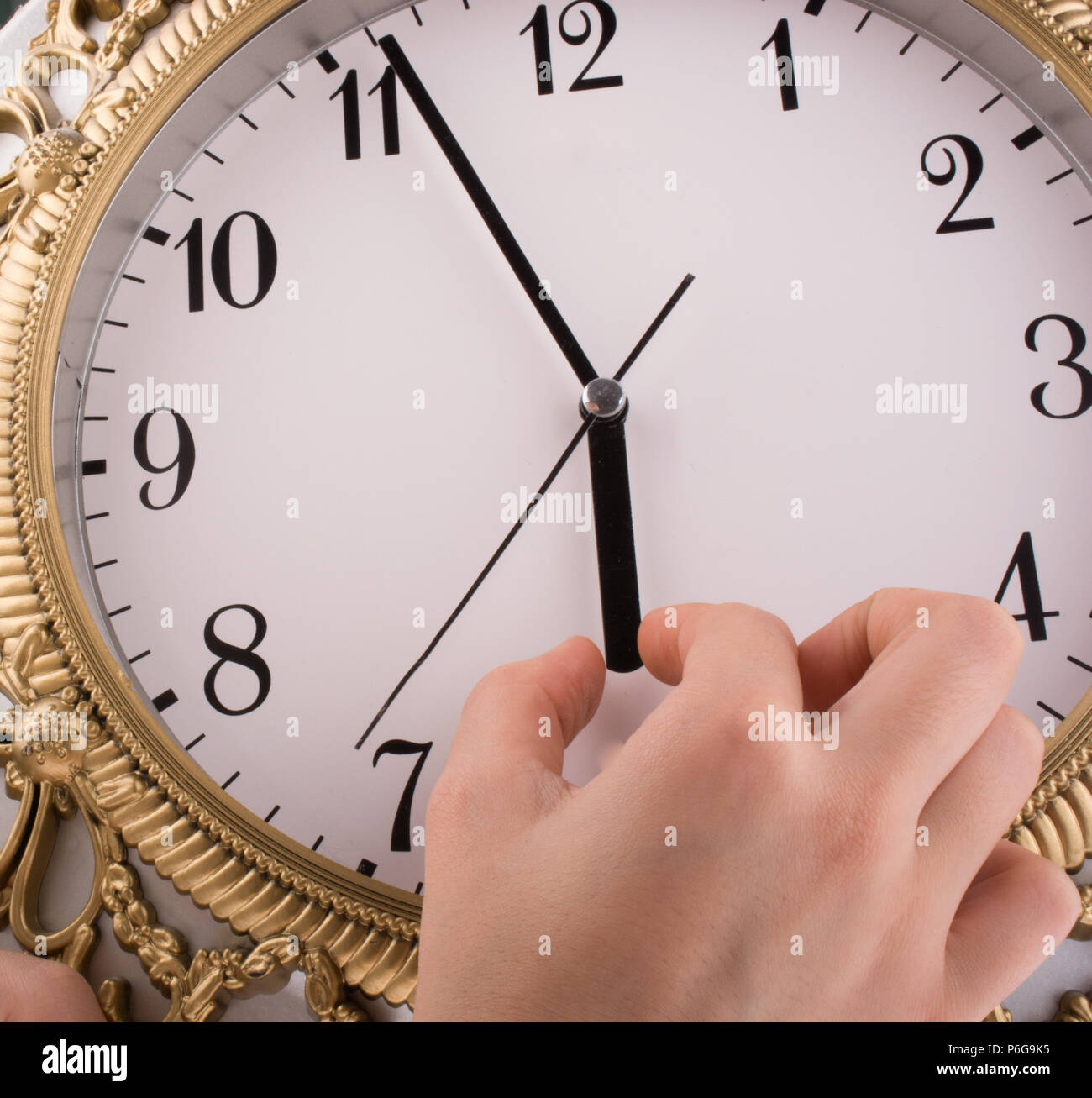hand in touch with a clock on a white background Stock Photo - Alamy