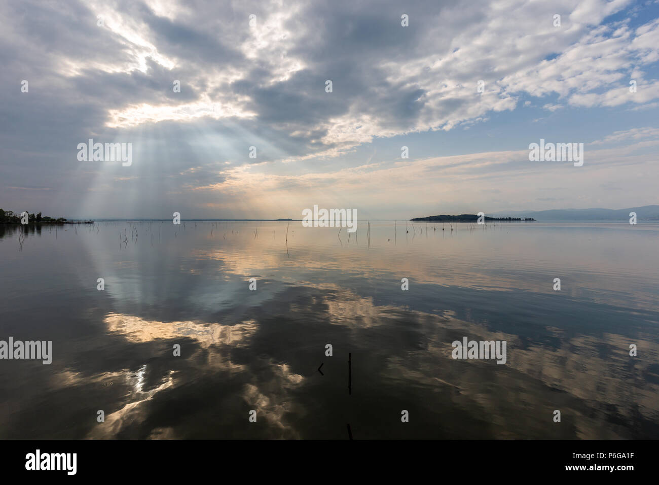 Perfectly symmetric and spectacular view of a lake, with clouds, sky ...