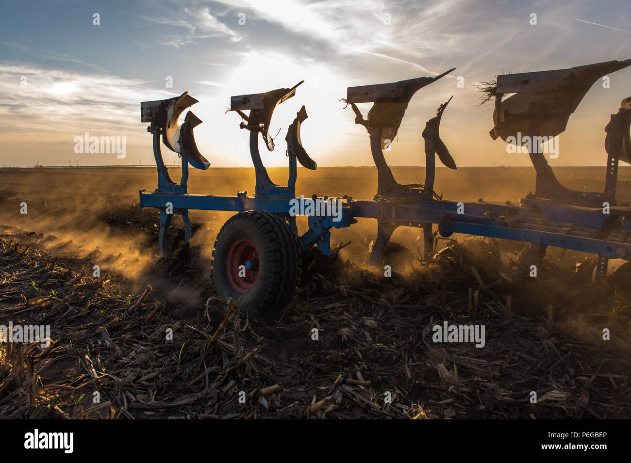 Tractor plowing fields -preparing land for sowing Stock Photo - Alamy