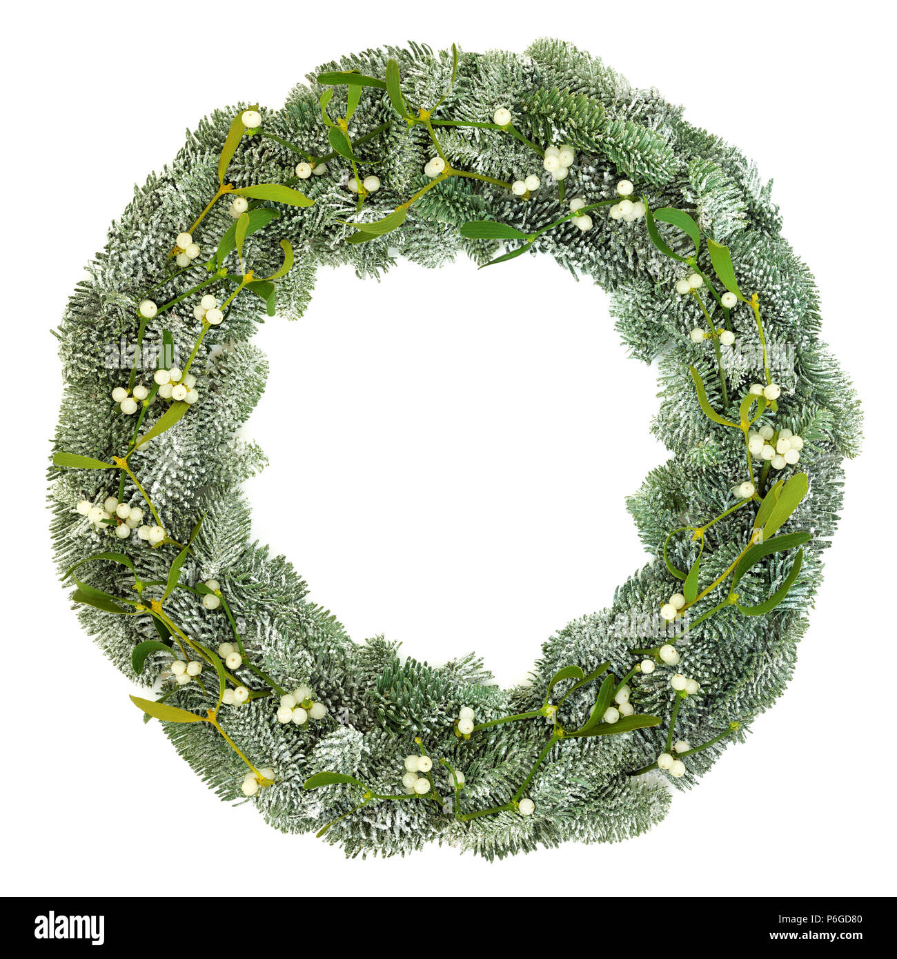 Winter and Christmas snow covered spruce fir wreath with mistletoe ...
