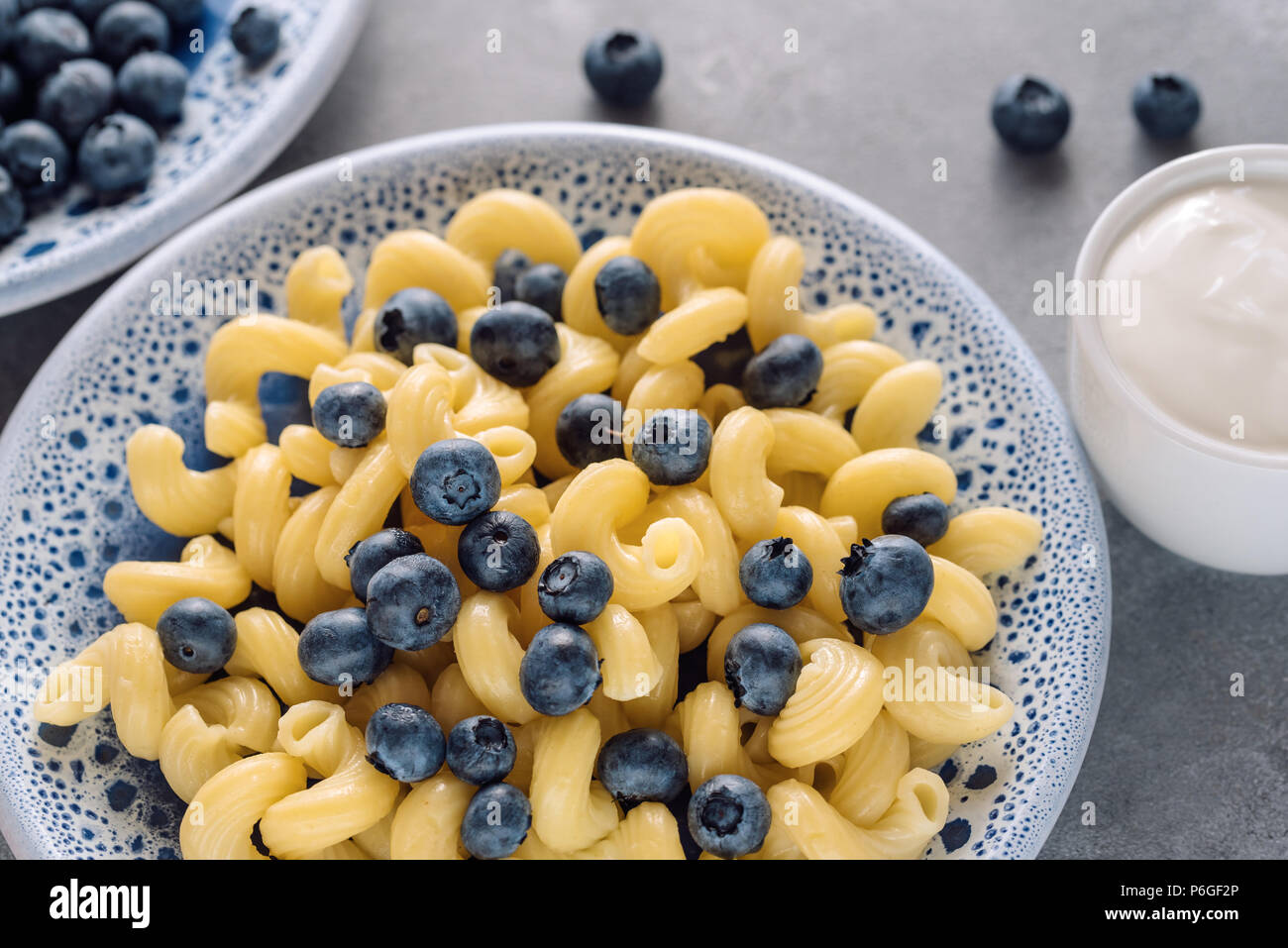 Pasta with blueberries and sour cream Stock Photo - Alamy