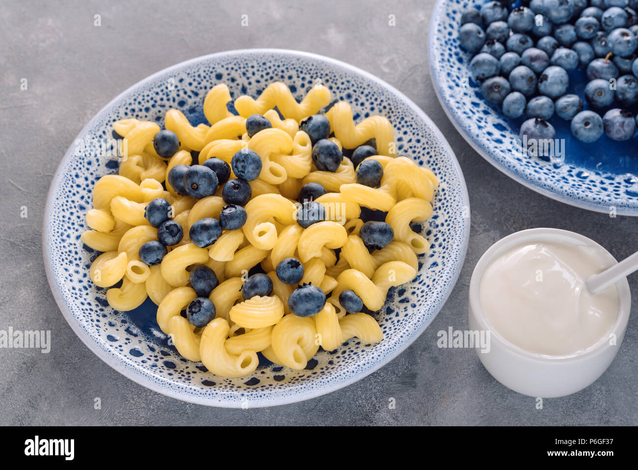 Pasta with blueberries and sour cream Stock Photo - Alamy