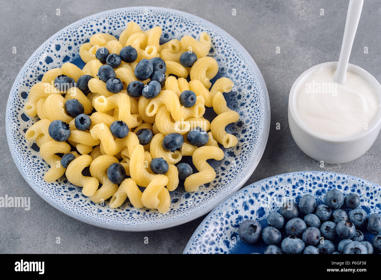 Pasta with blueberries and sour cream Stock Photo - Alamy