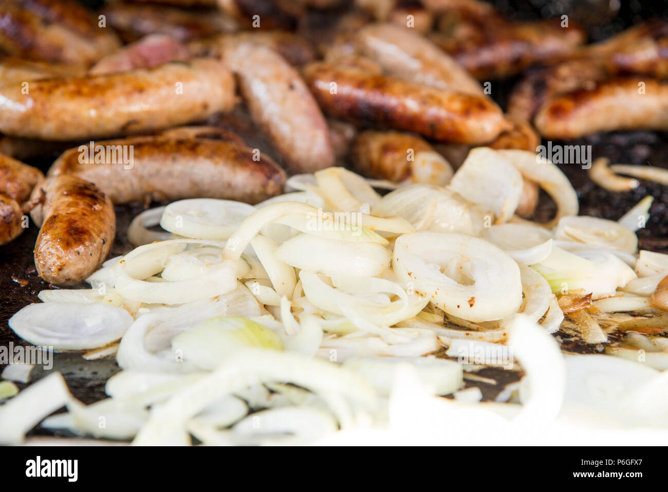 Wild Boar Sausage and Onions on grill in Food Street Market - Natural ...