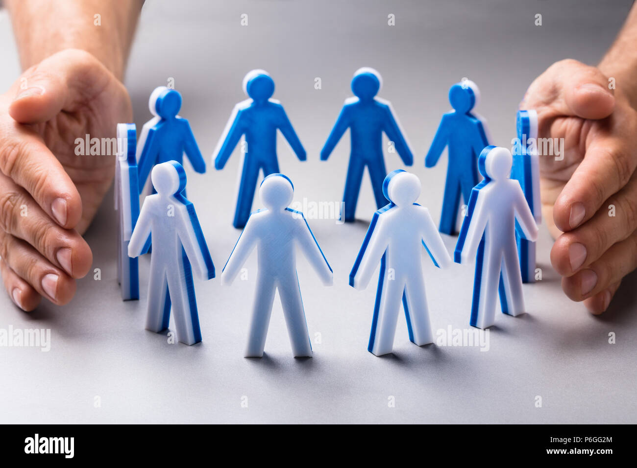 Close-up Of A Person's Hand Protecting Human Figures Forming Circle ...