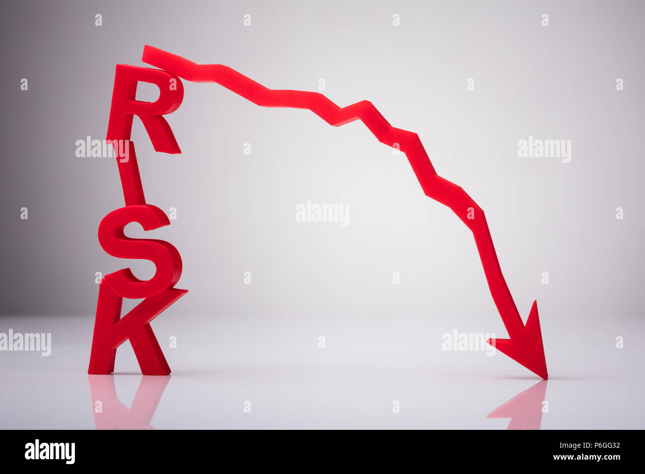 Red Risk Word With Declining Arrow On Reflective Background Stock Photo ...